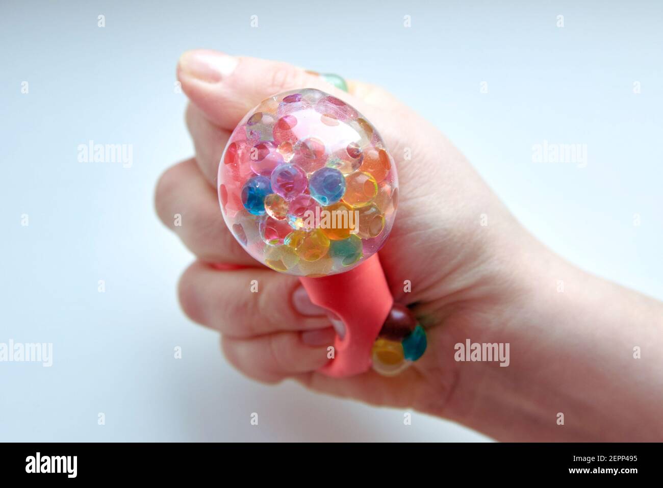 Soft rubber toy antistress in a woman's hand on a white background ...