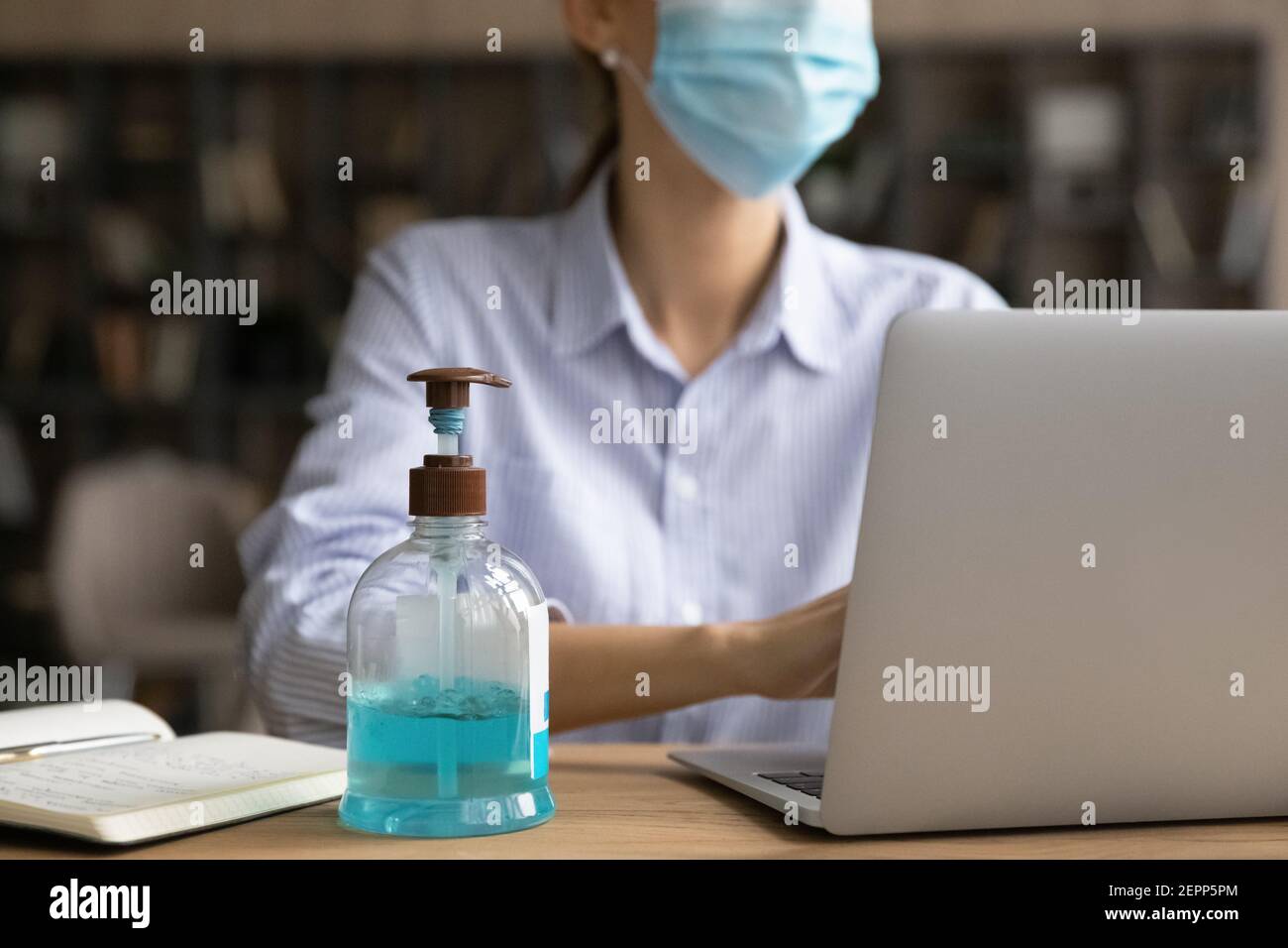 Female employee in mask typing hi-res stock photography and images - Alamy