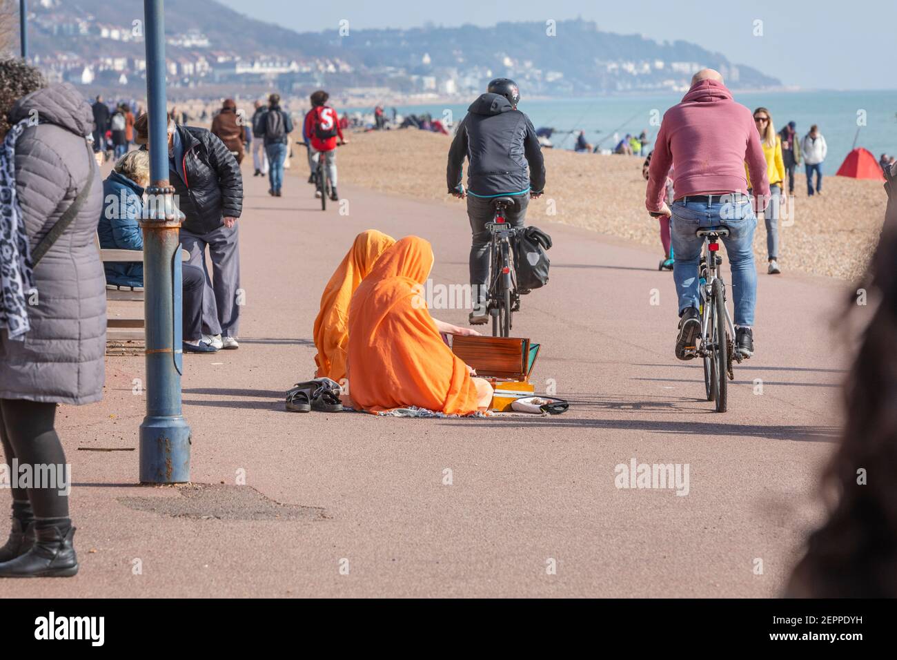 Two Hare Krishnas performing on a seaside promenade in Hythe, Kent ...