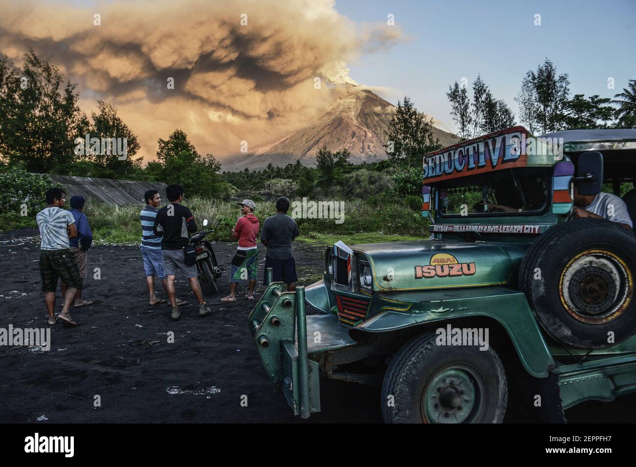 Residents look on as Mount Mayon erupts as seen from Legazpi, Albay ...
