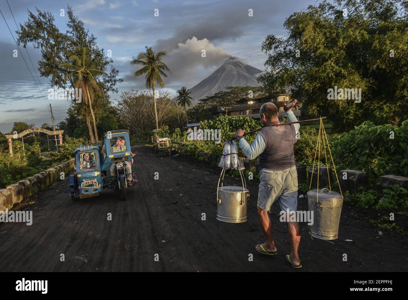 Residents go about daily life as Mount Mayon makes a mild eruption as ...