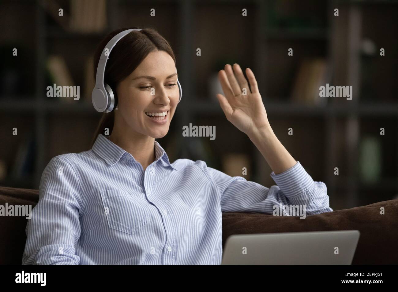 Smiling woman in headphones talk on video call Stock Photo - Alamy