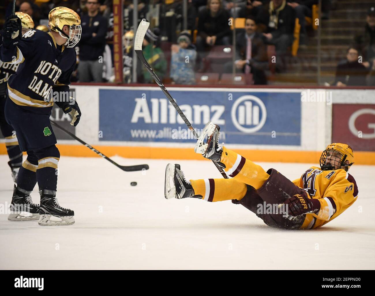 Notre Dame's Colin Theisen, left, knocks Minnesota's Ryan Lindgren (5 ...
