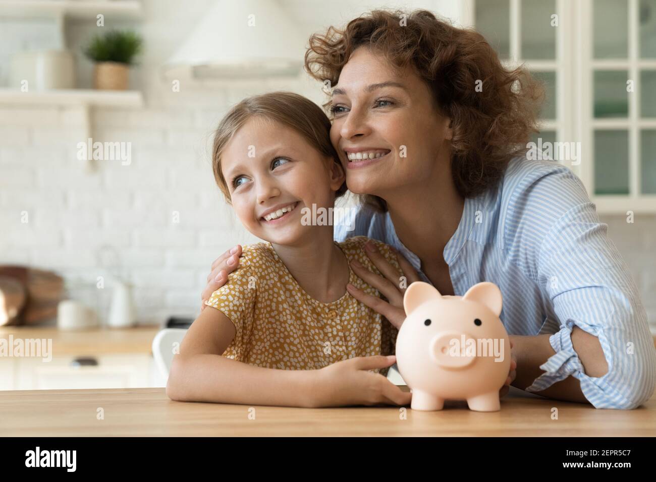 Children with piggy bank hi-res stock photography and images - Alamy