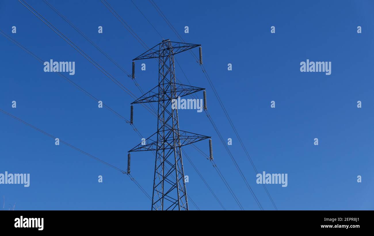 Electricity pylon against deep blue sky with space for copt Stock Photo ...