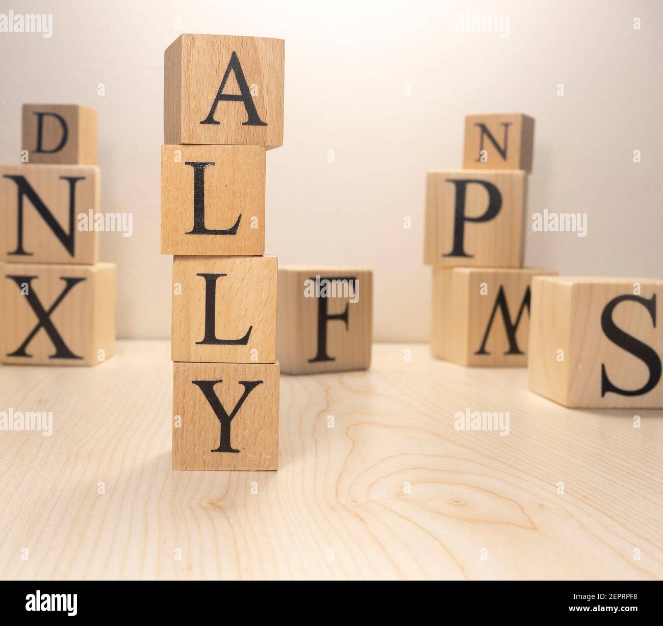 The word Ally is from wooden cubes. Background from wooden letters ...