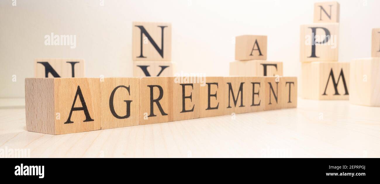 The word agreement is made of wooden cubes. Background from wooden ...