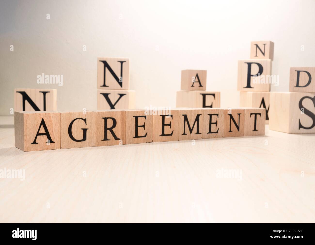 The word agreement is made of wooden cubes. Background from wooden ...
