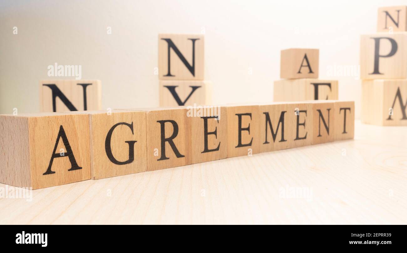 The word agreement is made of wooden cubes. Background from wooden ...
