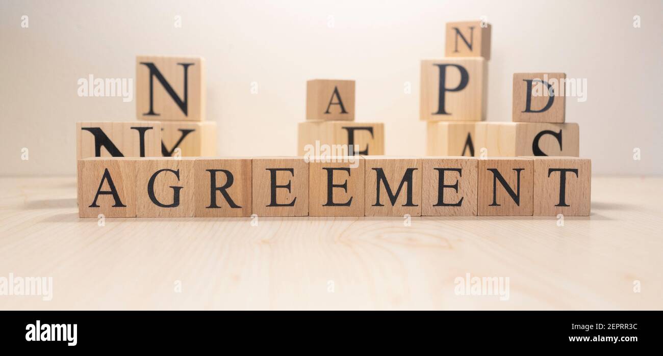 The word agreement is made of wooden cubes. Background from wooden ...