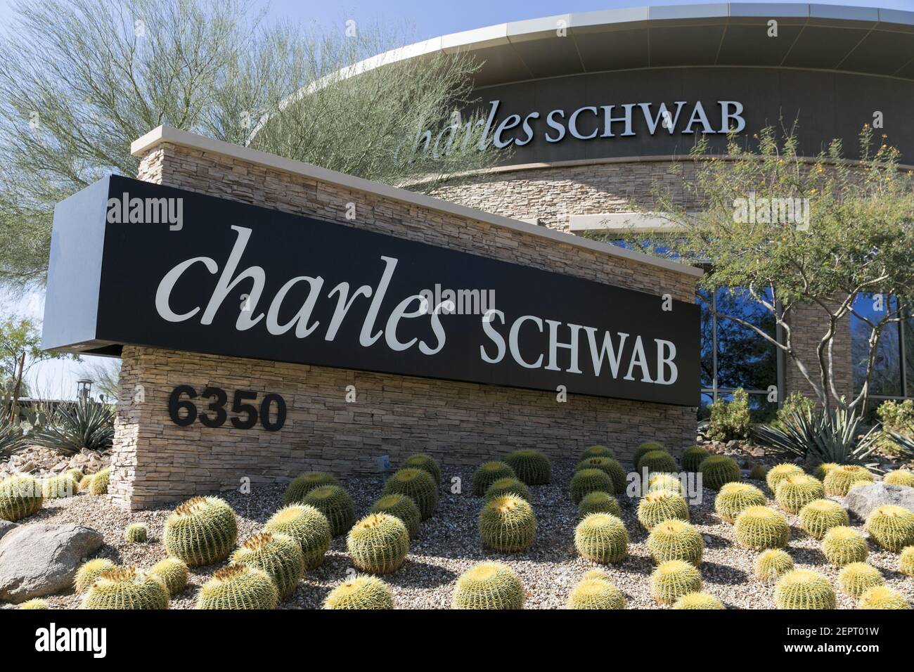 A logo sign outside of a facility occupied by the The Charles Schwab ...