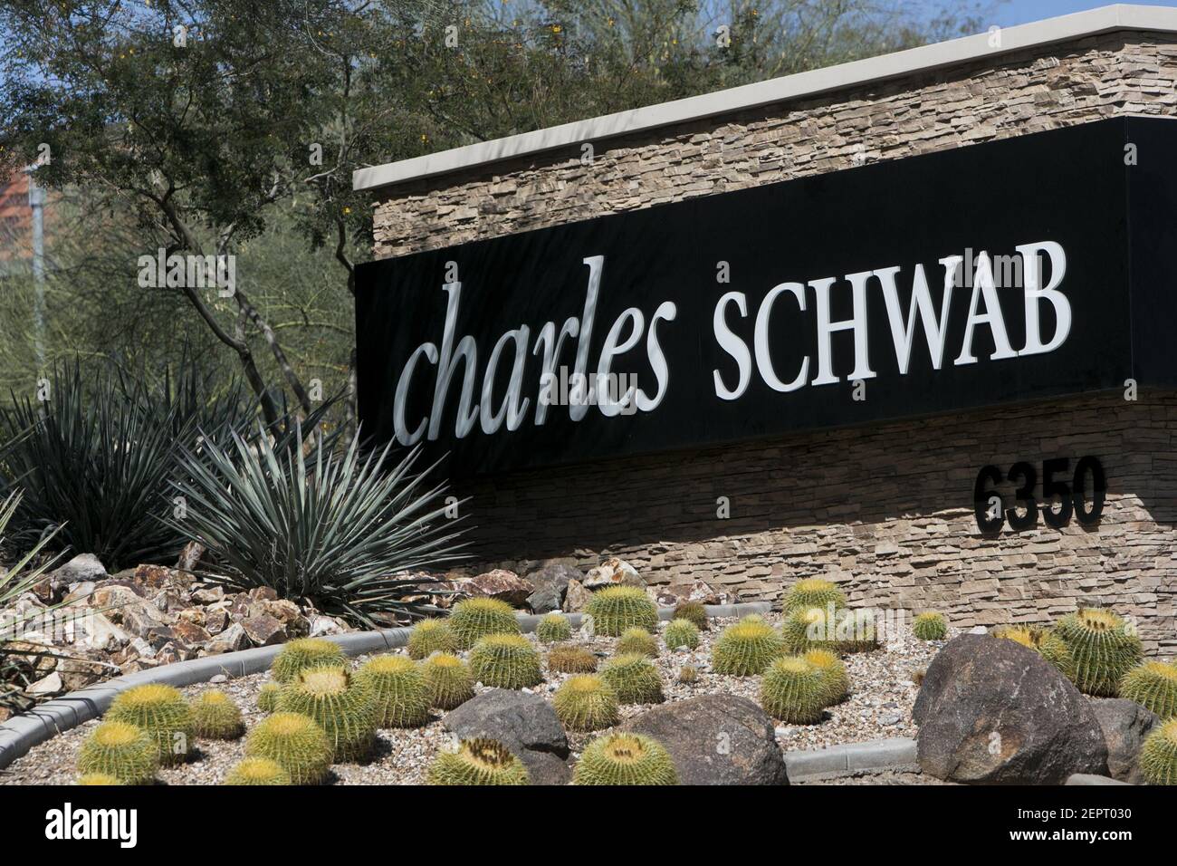 A logo sign outside of a facility occupied by the The Charles Schwab ...