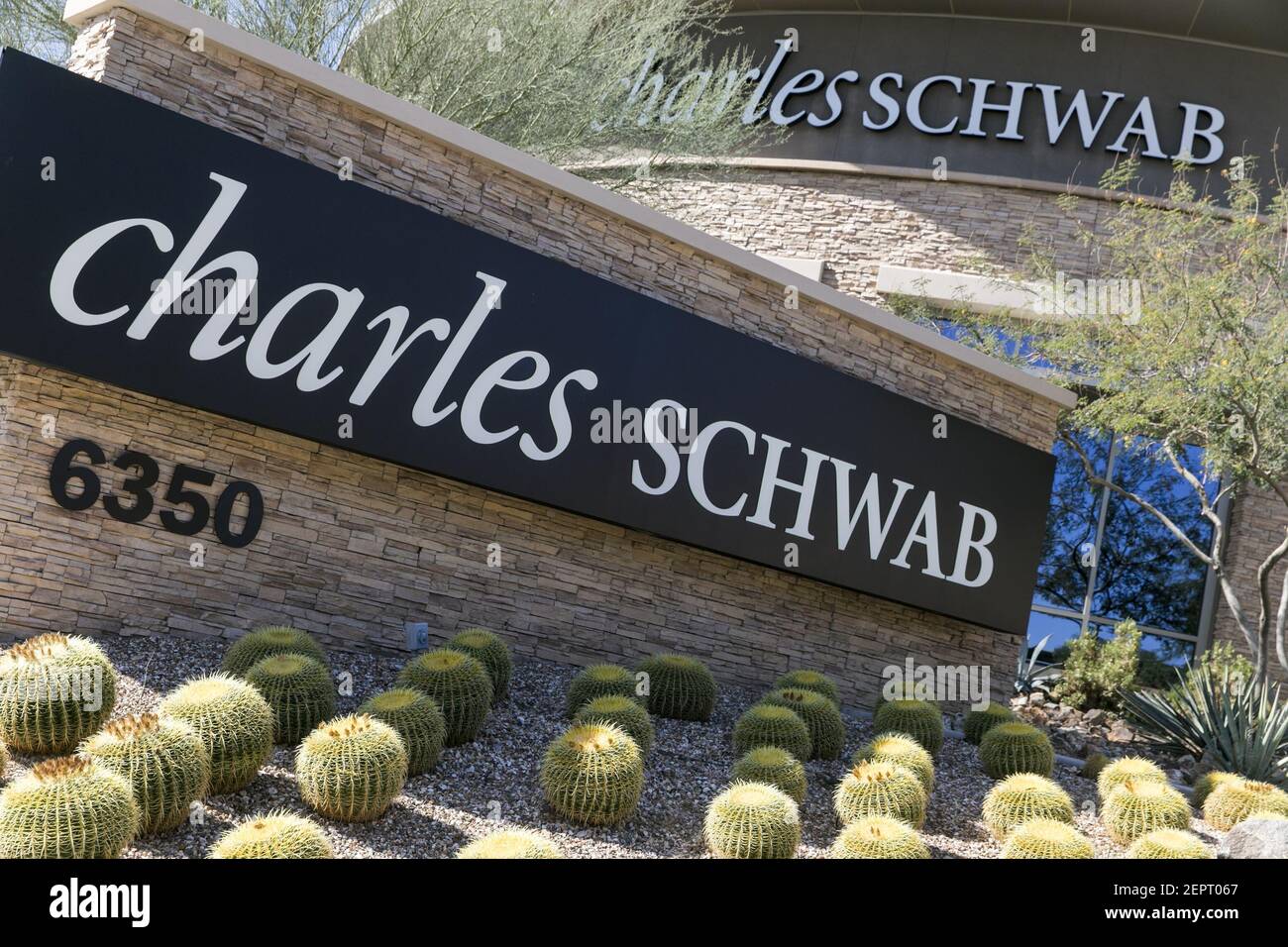 A logo sign outside of a facility occupied by the The Charles Schwab ...