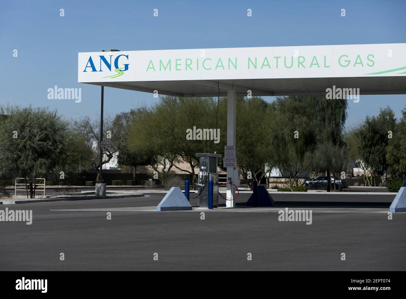 A logo sign outside of a American Natural Gas filling station in ...