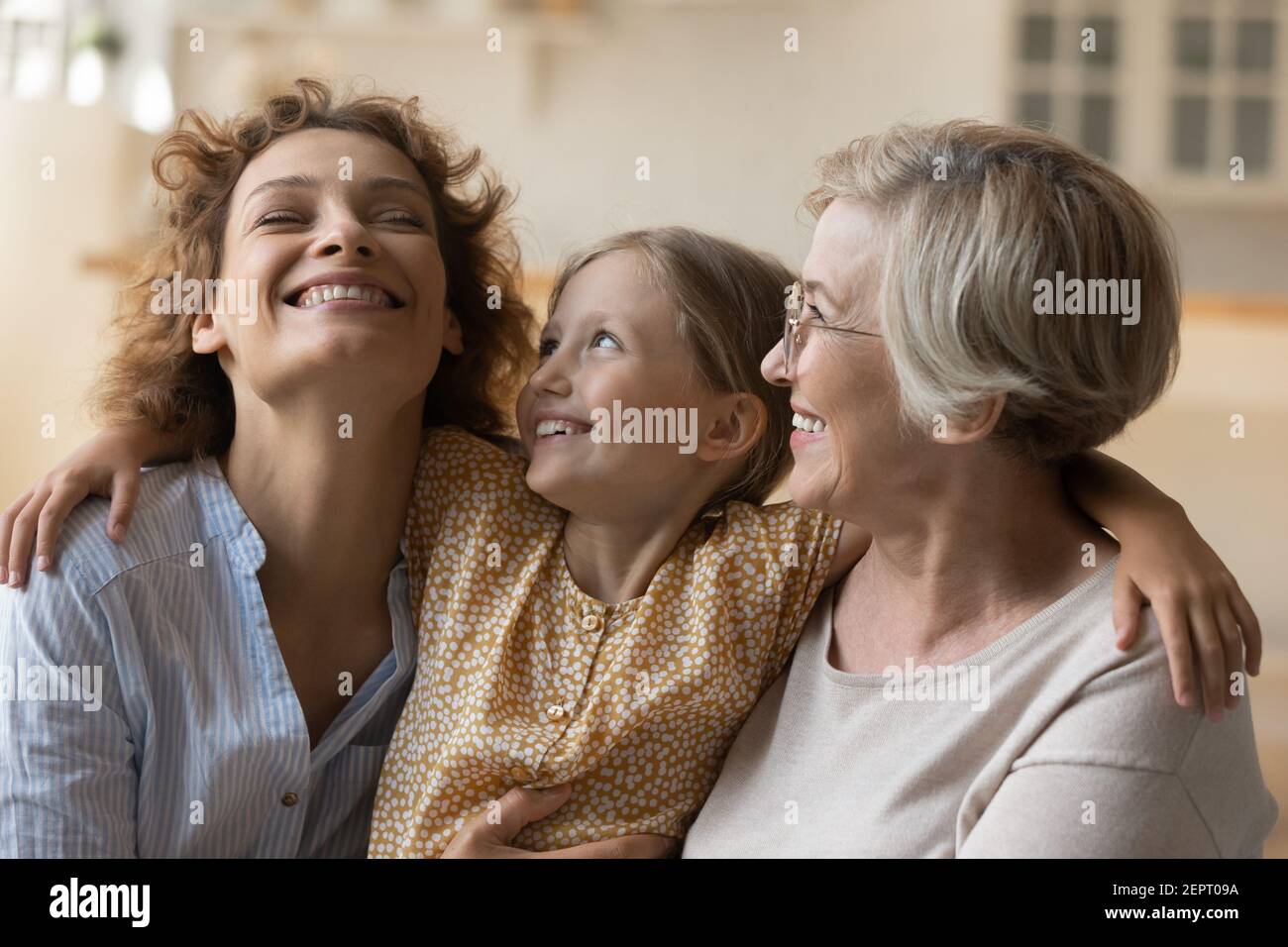 Loving family of three diverse age females hug on sofa Stock Photo - Alamy