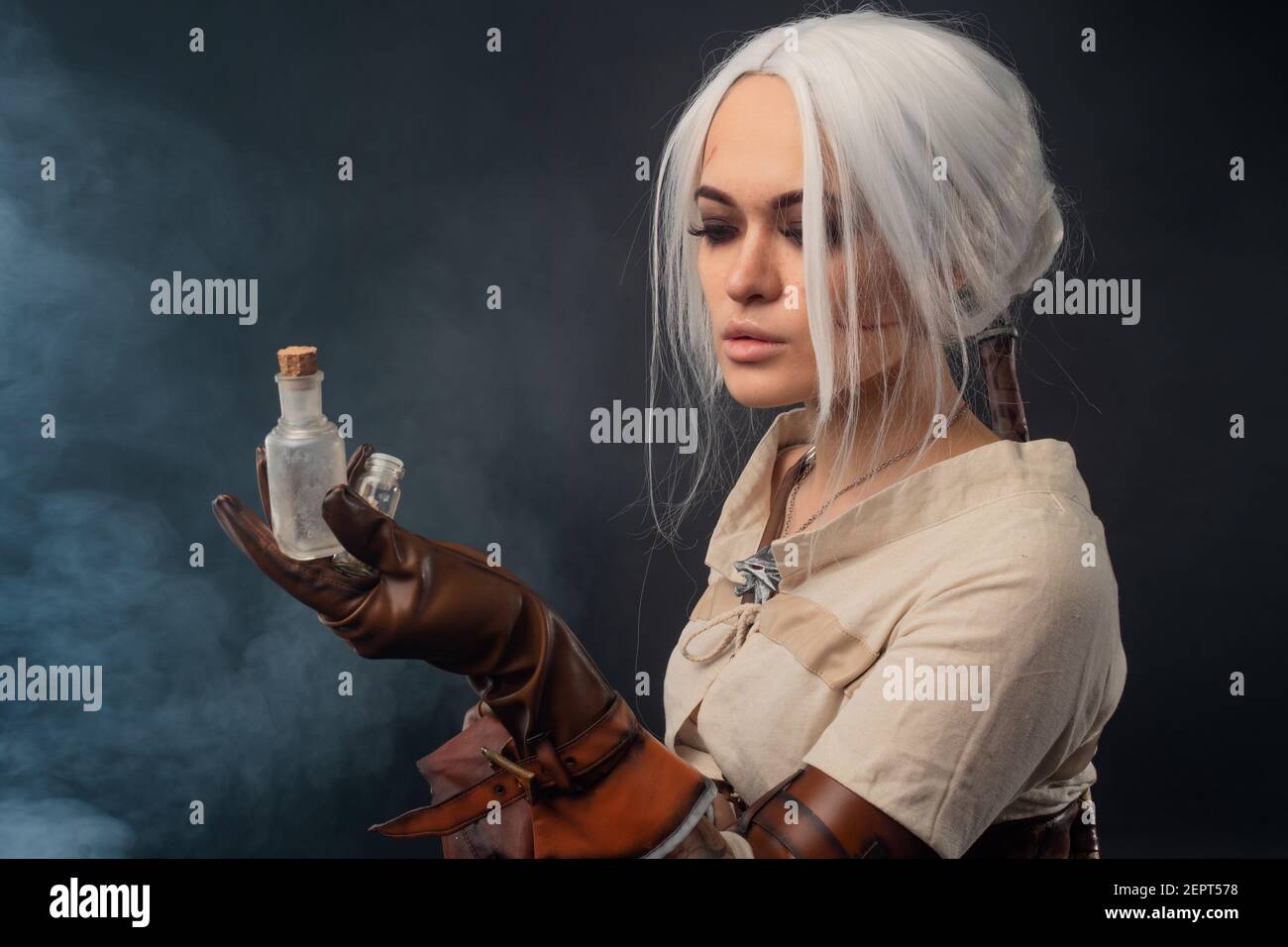 A young warrior with a sword on a dark background. Fantasy heroine ...