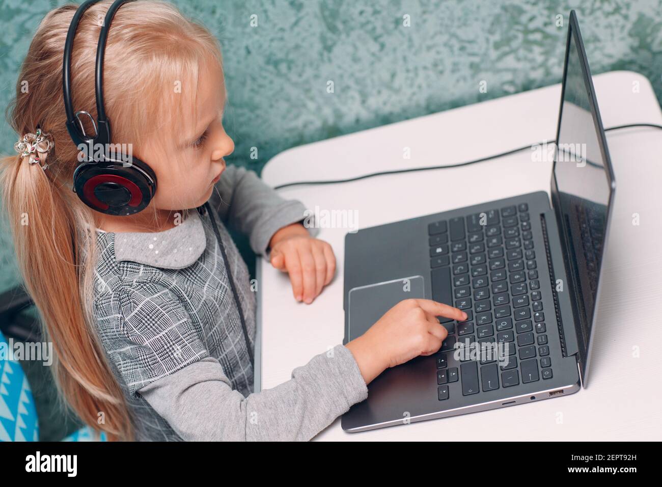 Young student little girl with laptop learning and preparing back to ...