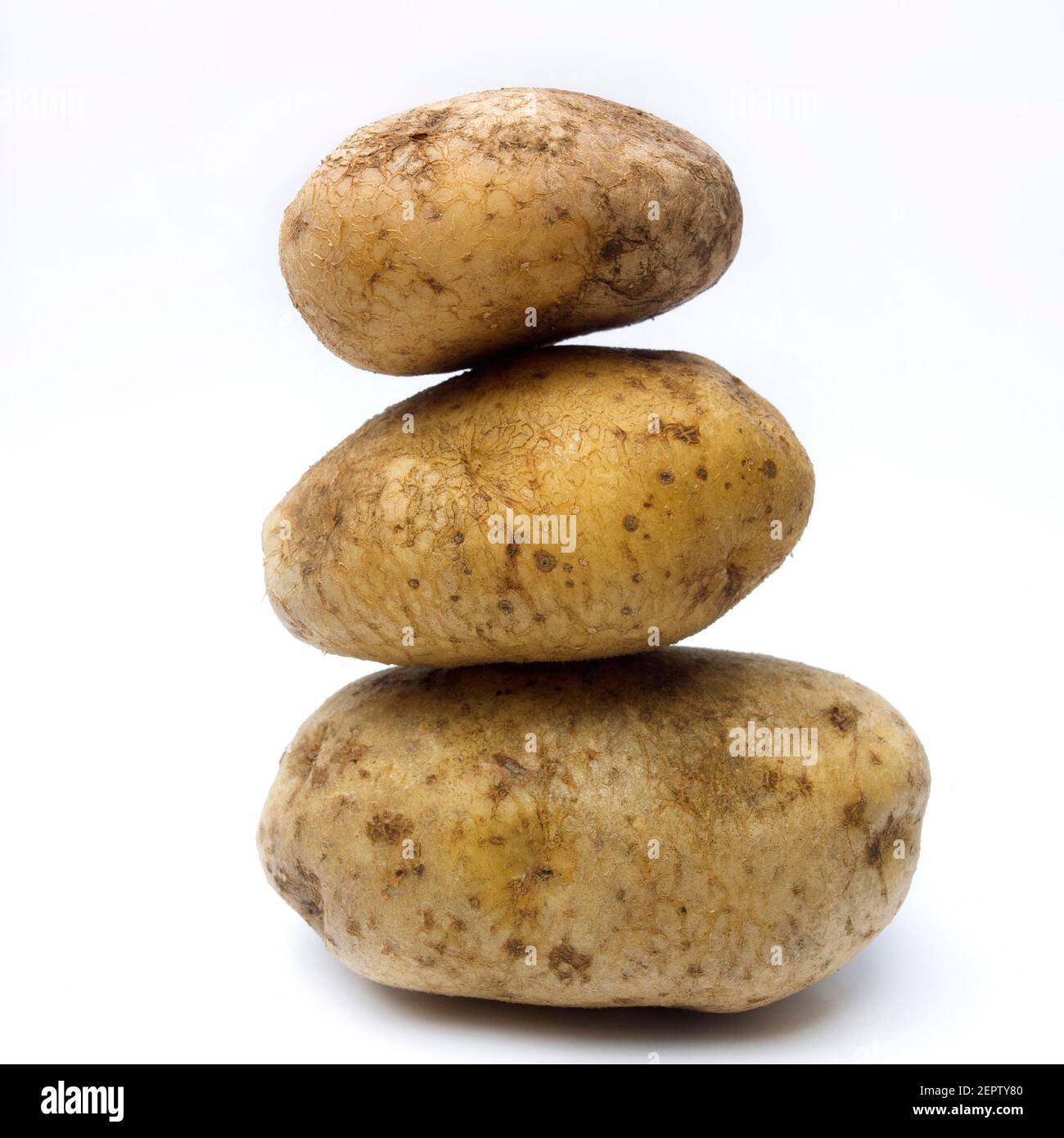 Stacked potatoes showcasing various shapes and sizes under natural ...