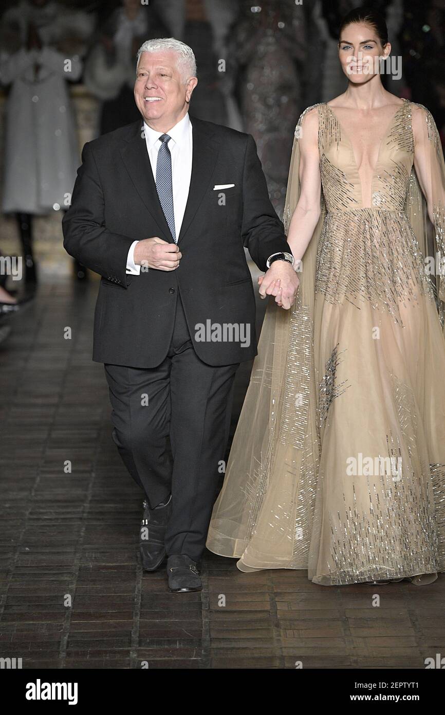 Designer Dennis Basso and Model Hilary Rhoda walks on the runway during ...