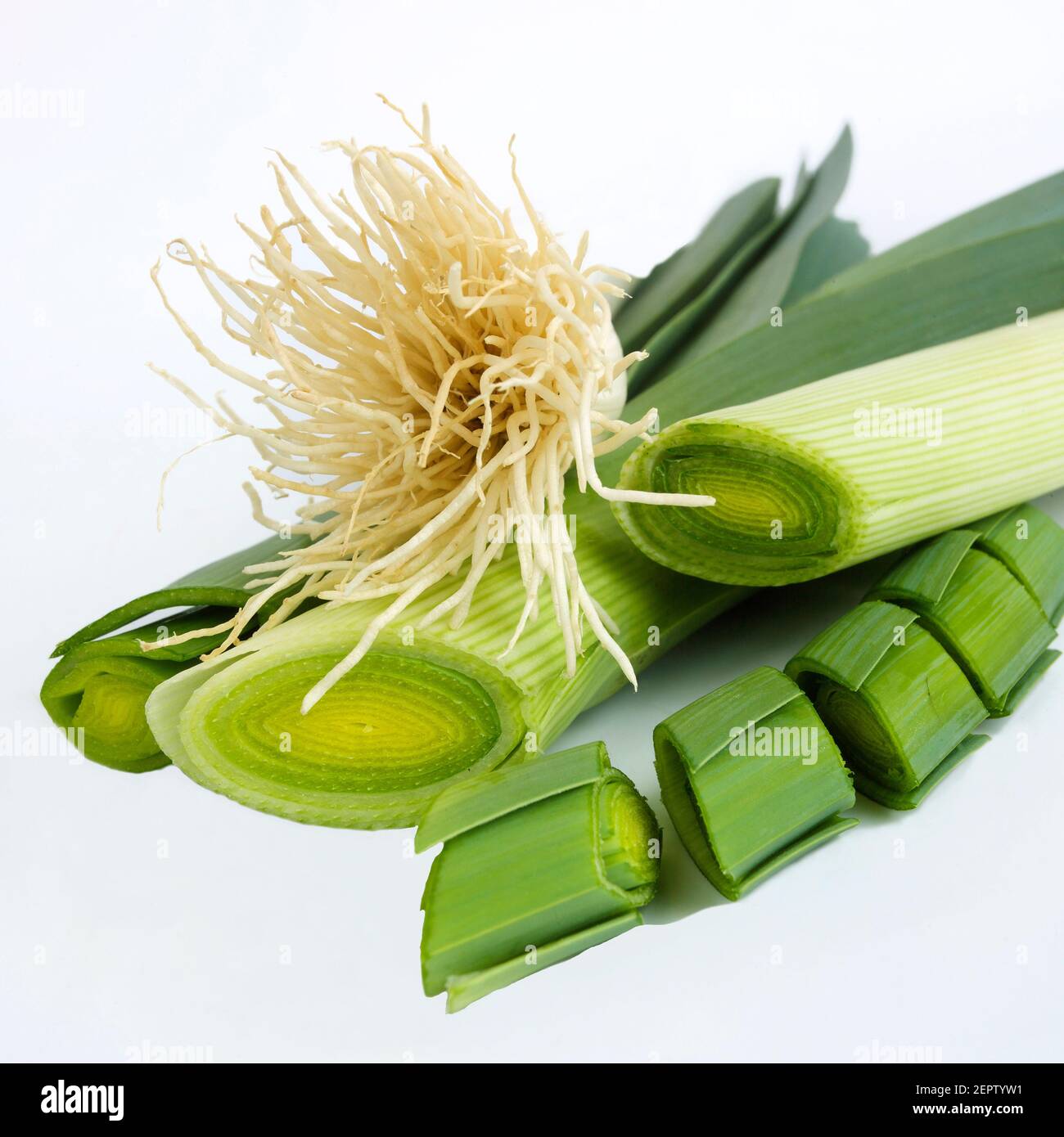 Cut leeks tied with string, on a white background Stock Photo - Alamy