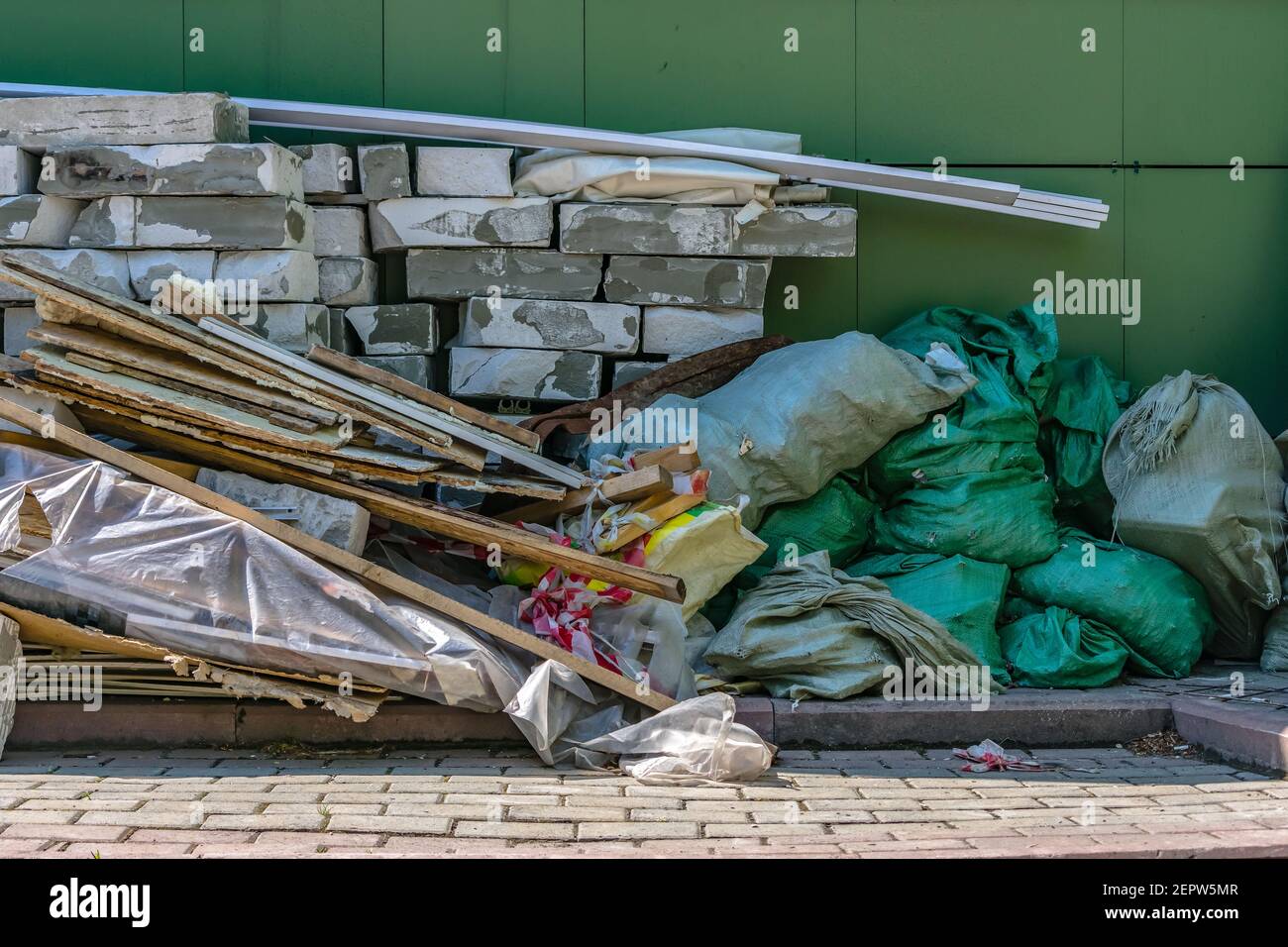 Construction waste dump in the shade behind a building under ...