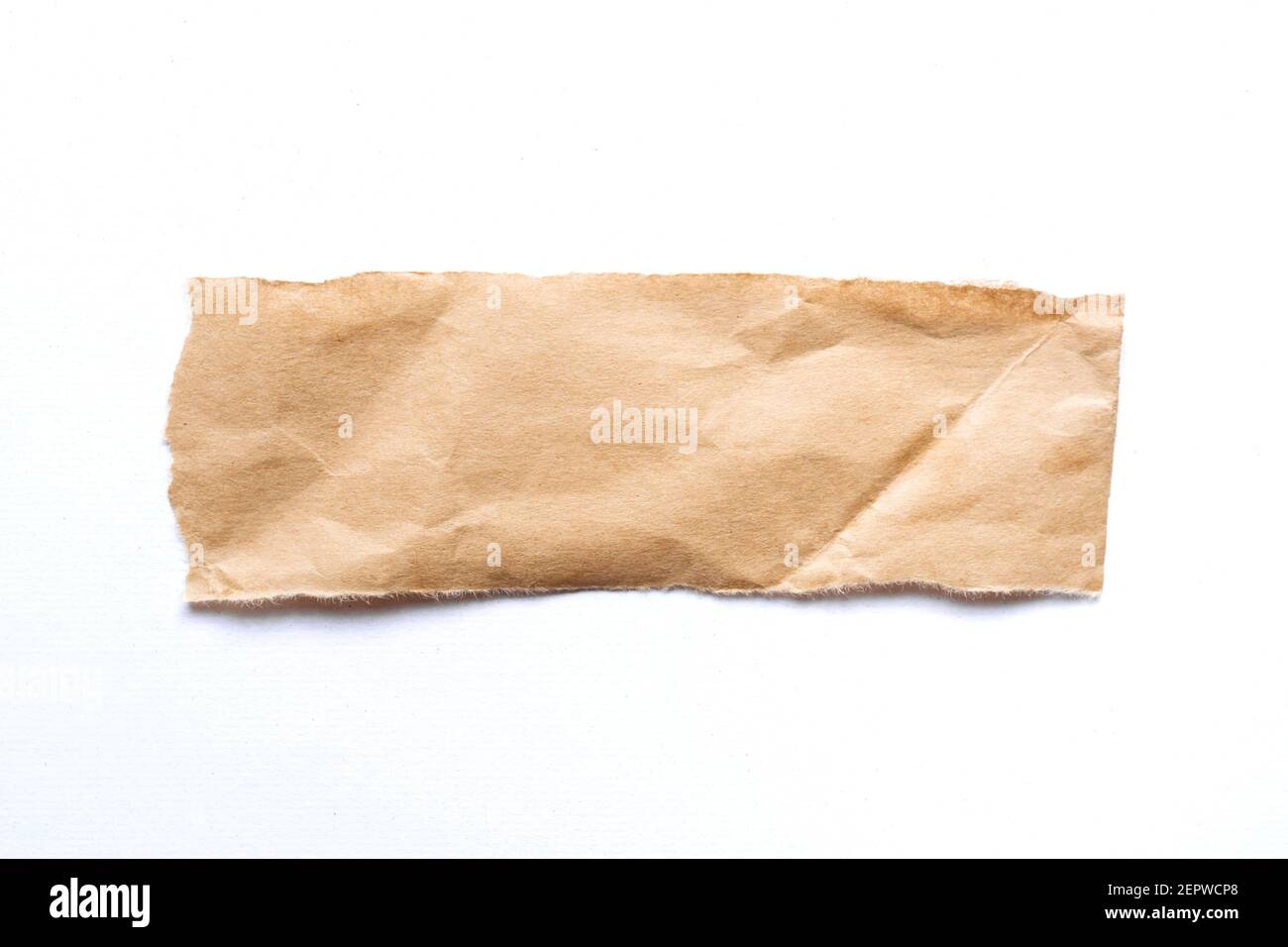 close up of a ripped piece of brown spaper on white background Stock ...
