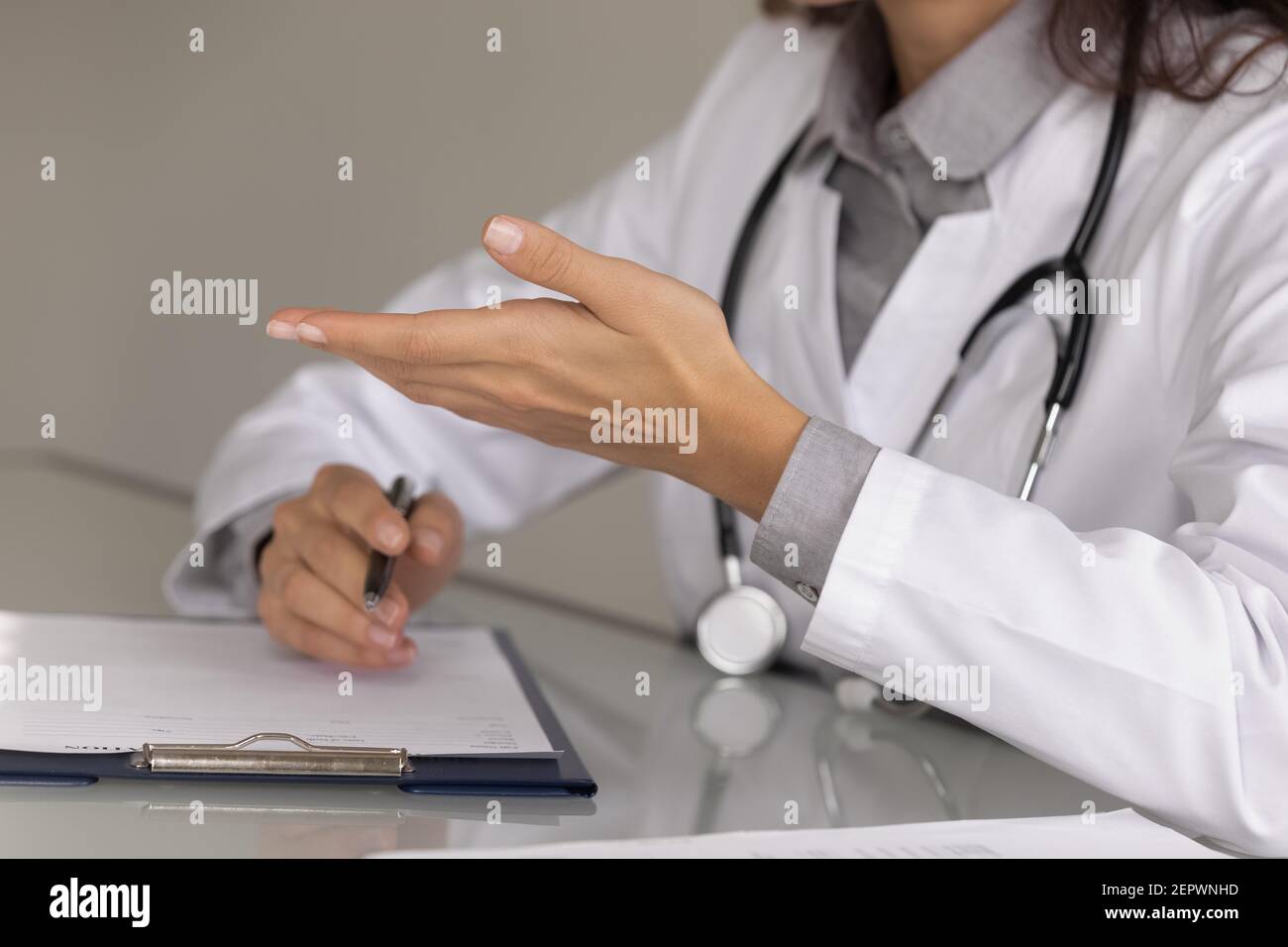 Close up hands of female doctor wearing uniform consulting patient ...