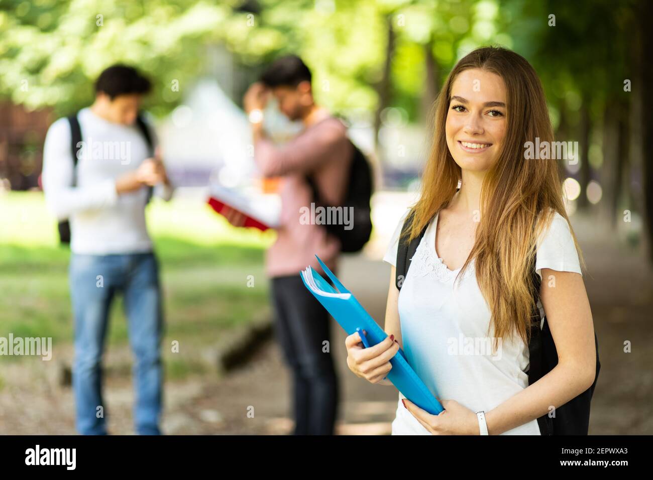 Happy students outdoor smiling cheerfully Stock Photo - Alamy