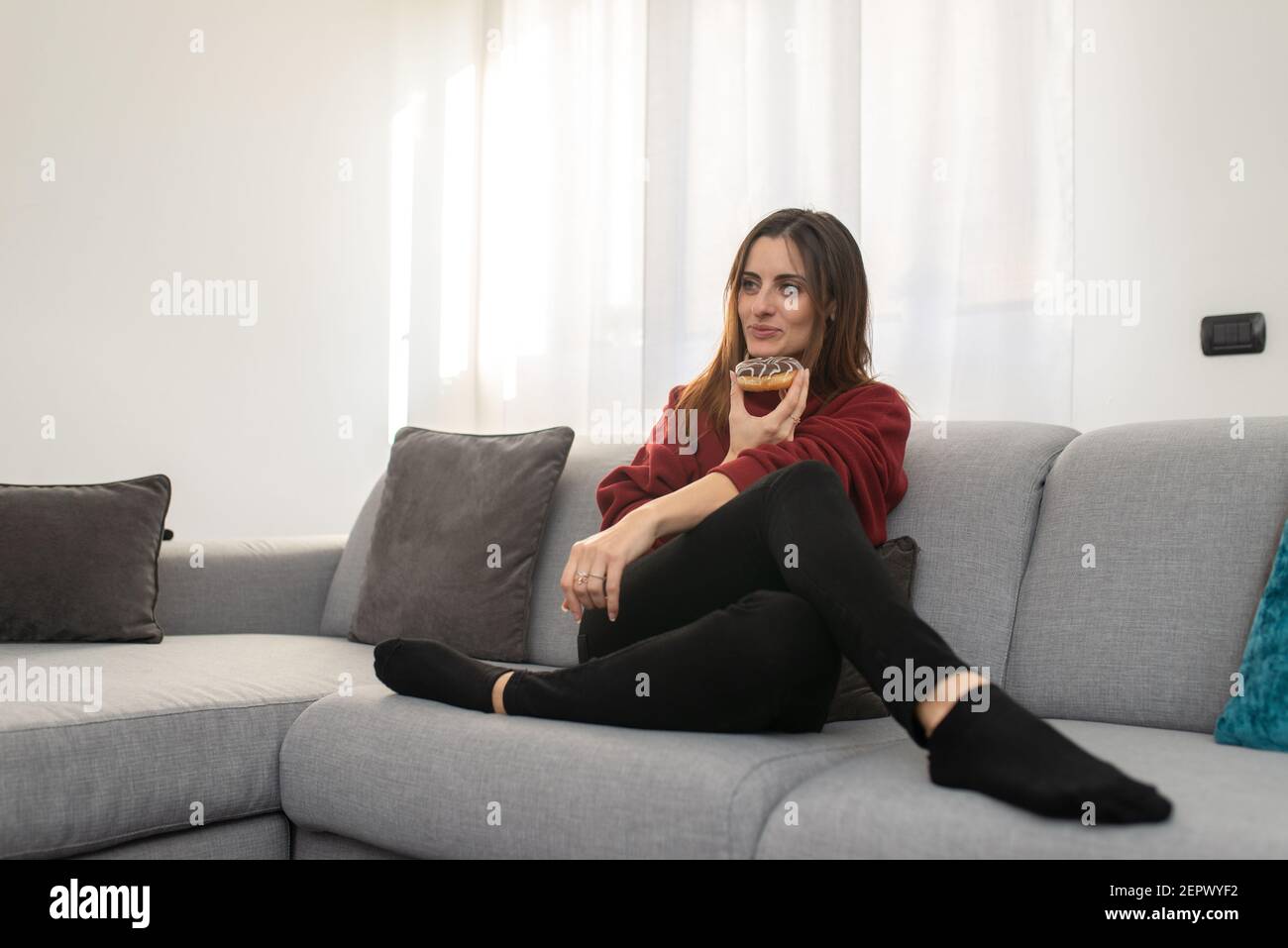 Woman relaxing on couch eating hi-res stock photography and images - Alamy