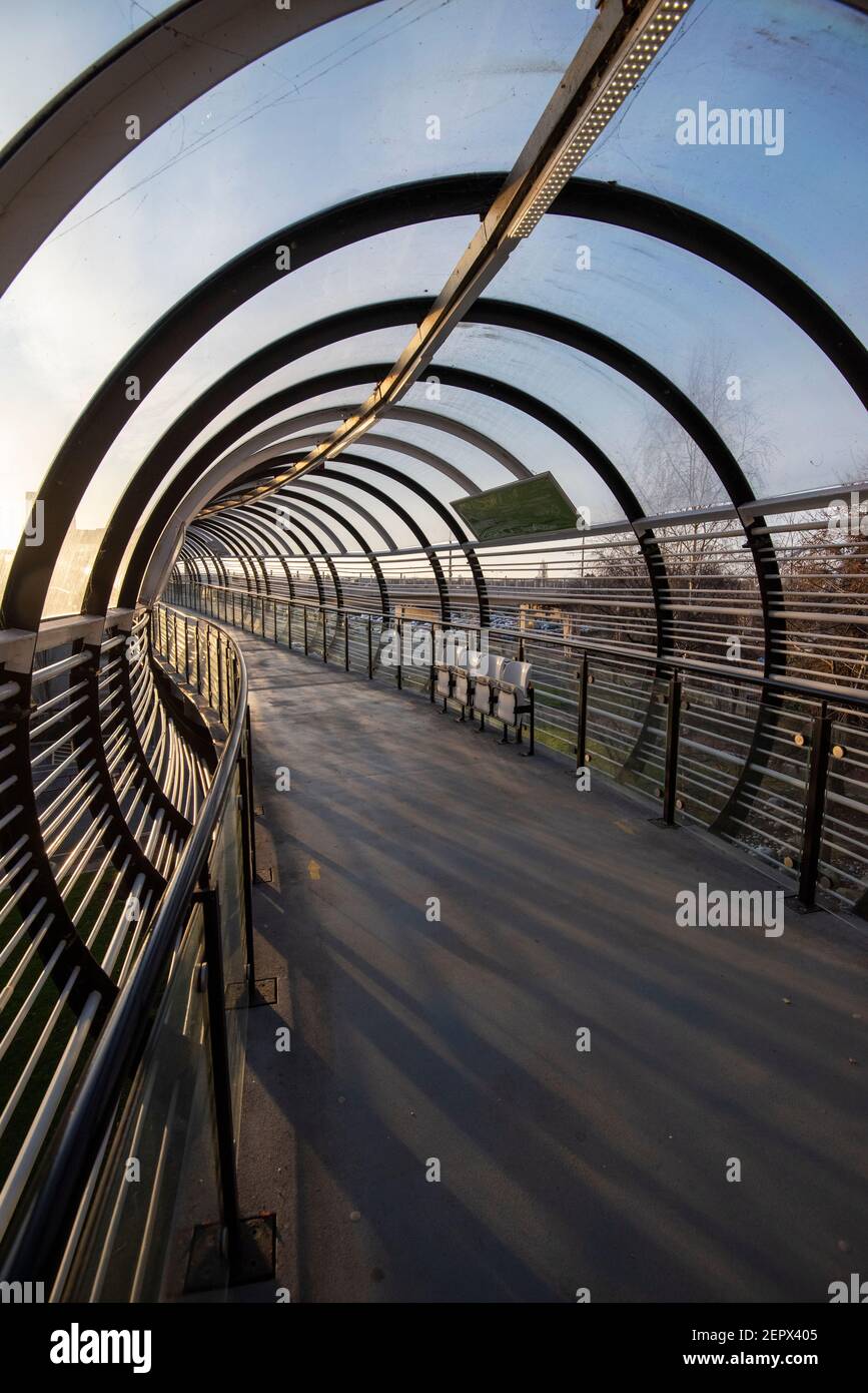 Morning light on the Sir Peter Mansfield tram bridge at the Queens ...