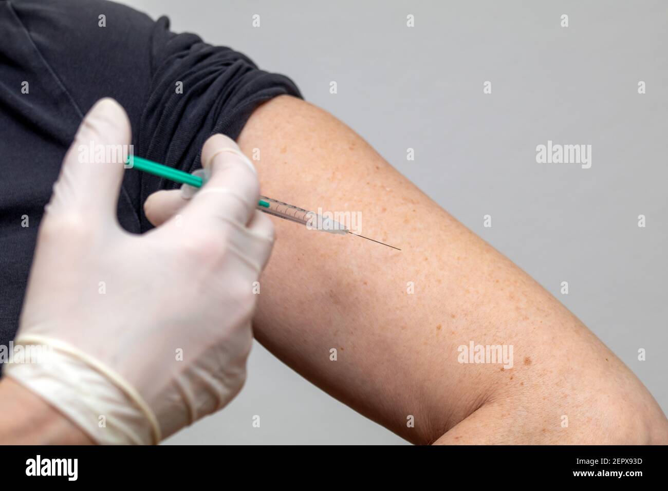 Nurse giving injection in upper arm hi-res stock photography and images ...