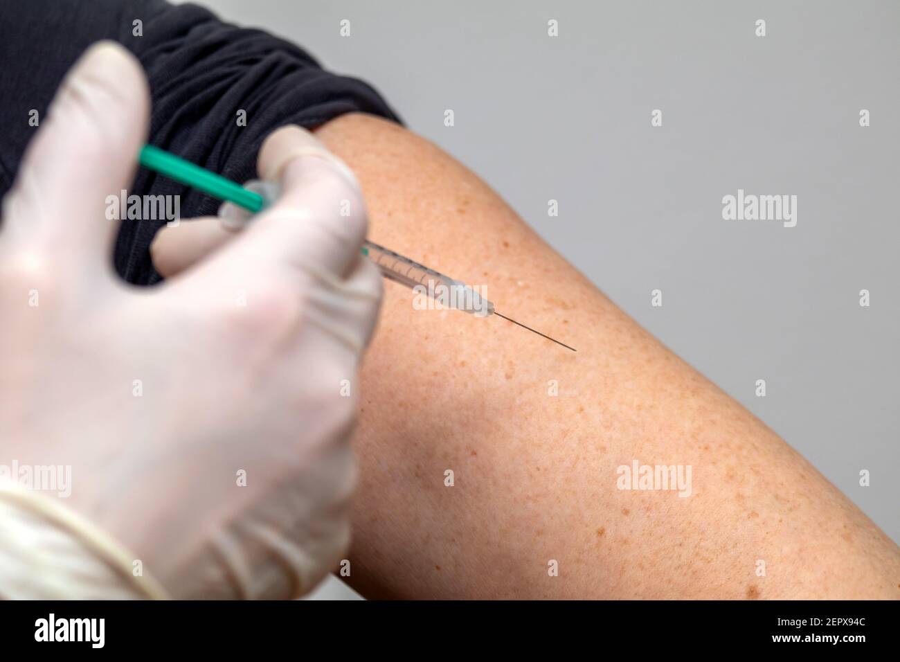 Nurse giving injection in upper arm hi-res stock photography and images ...