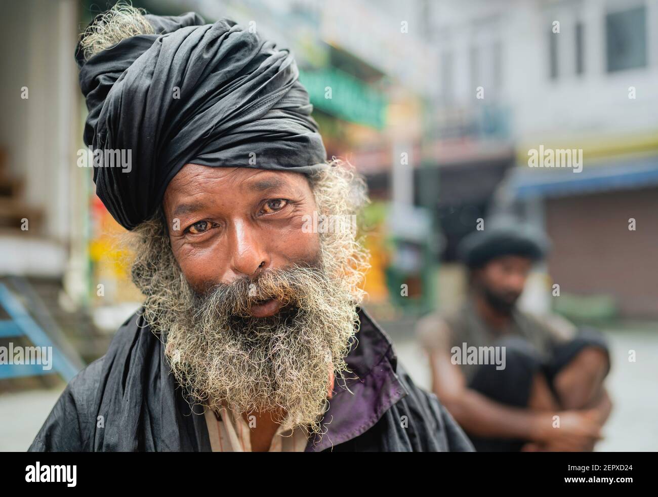 Candid portrait of Hindu holy man with beard and turban with sad ...