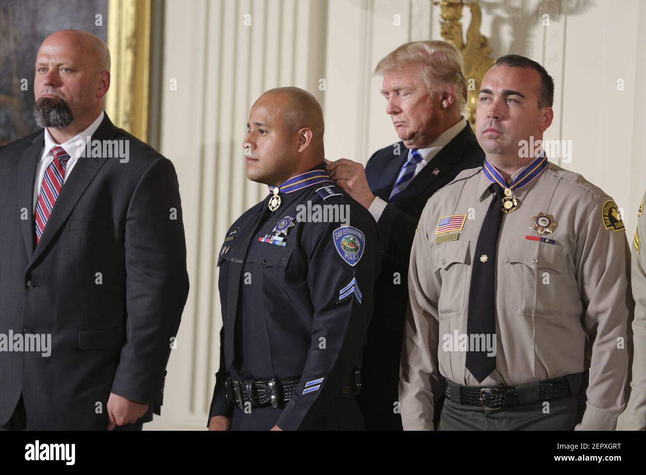 President Donald Trump, center right, presents the Public Safety Medal ...