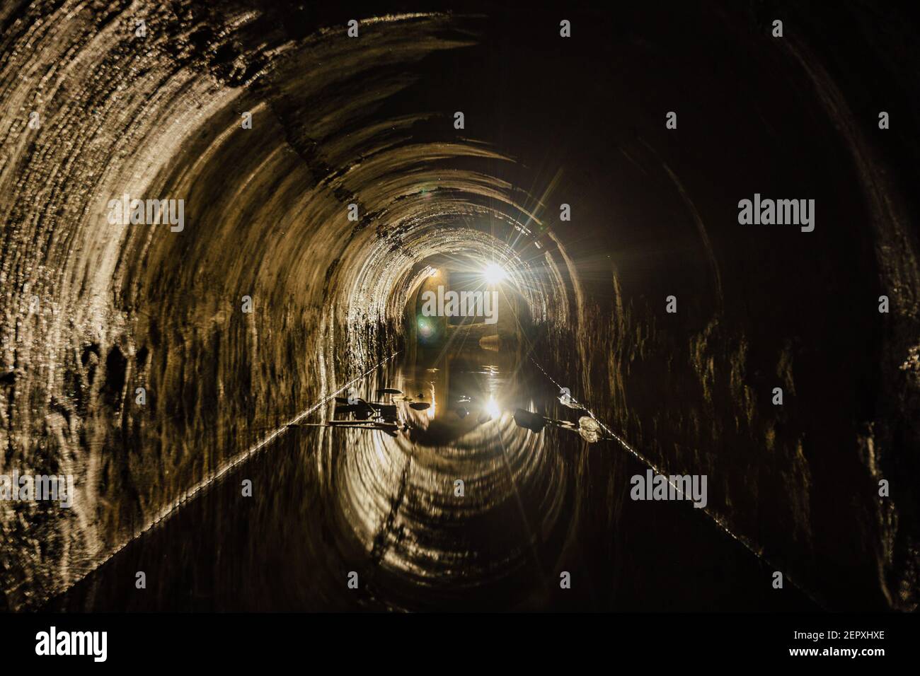 Flooded vaulted sewer tunnel with water reflection Stock Photo - Alamy