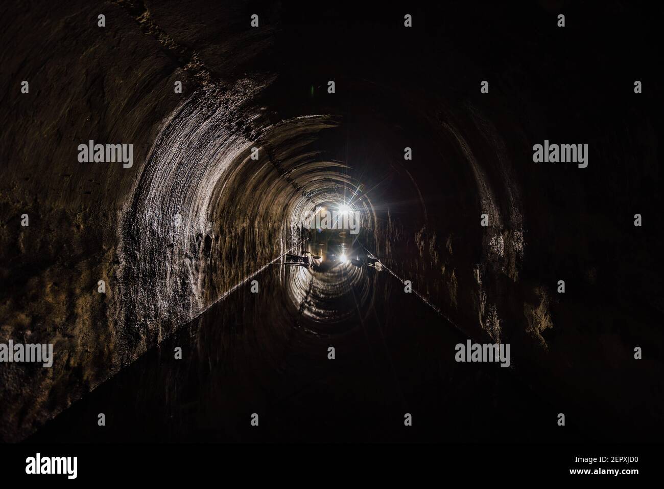 Flooded vaulted sewer tunnel with water reflection Stock Photo - Alamy