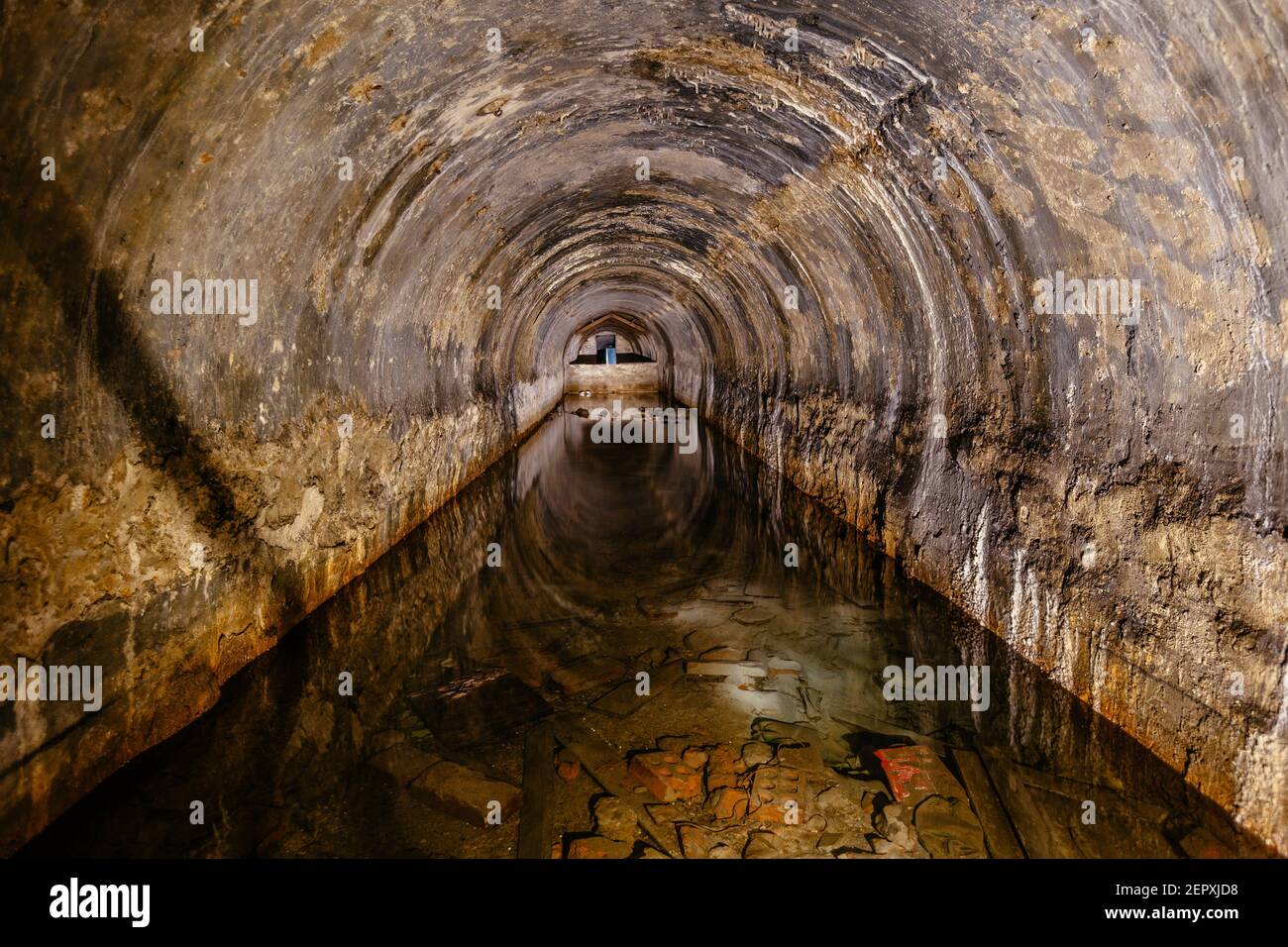 Flooded vaulted sewer tunnel with water reflection Stock Photo - Alamy