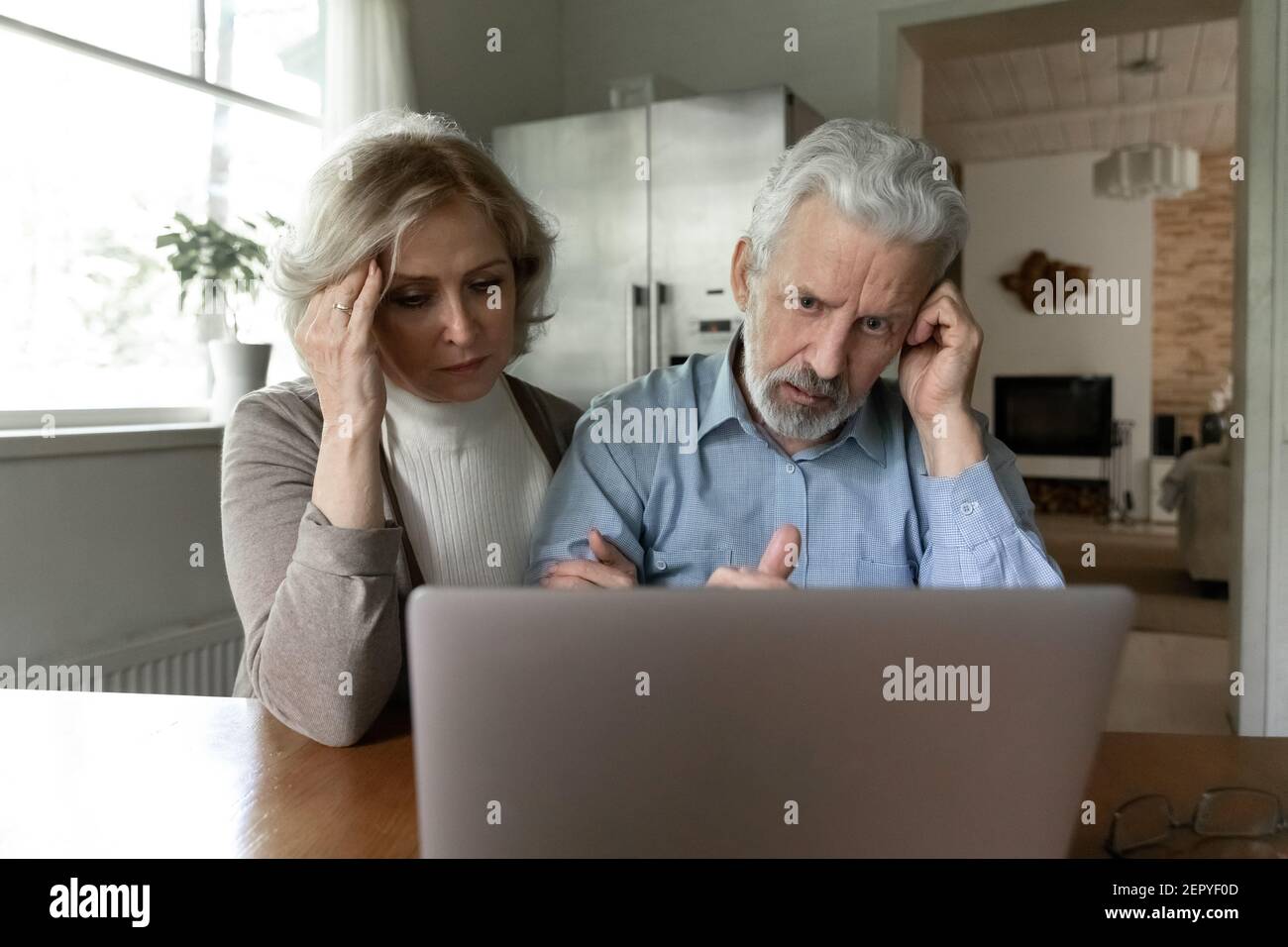 Upset senior couple getting shocking bad news Stock Photo - Alamy