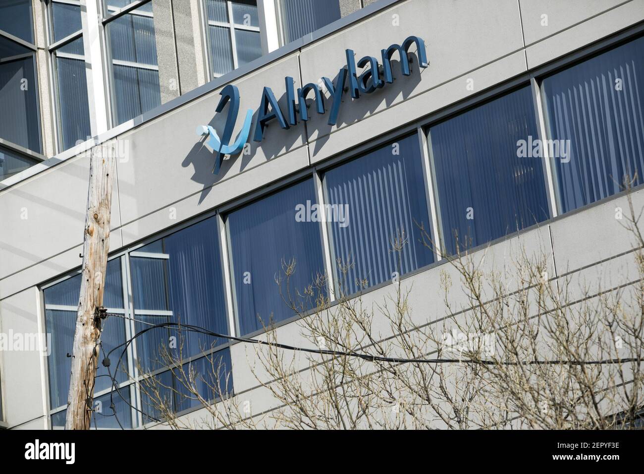 A logo sign outside of the headquarters of Alnylam Pharmaceuticals in ...