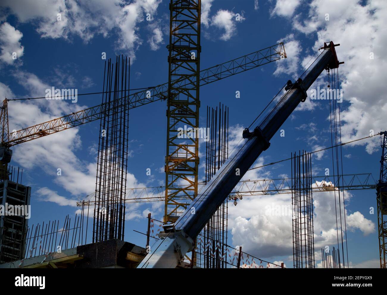 Cranes on a construction site. Industrial image Stock Photo - Alamy