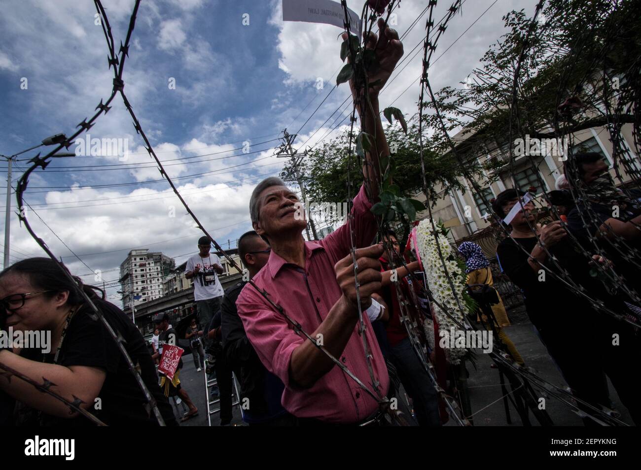 BAYAN president Satur Ocampo hangs a flower for the victims of Martial ...