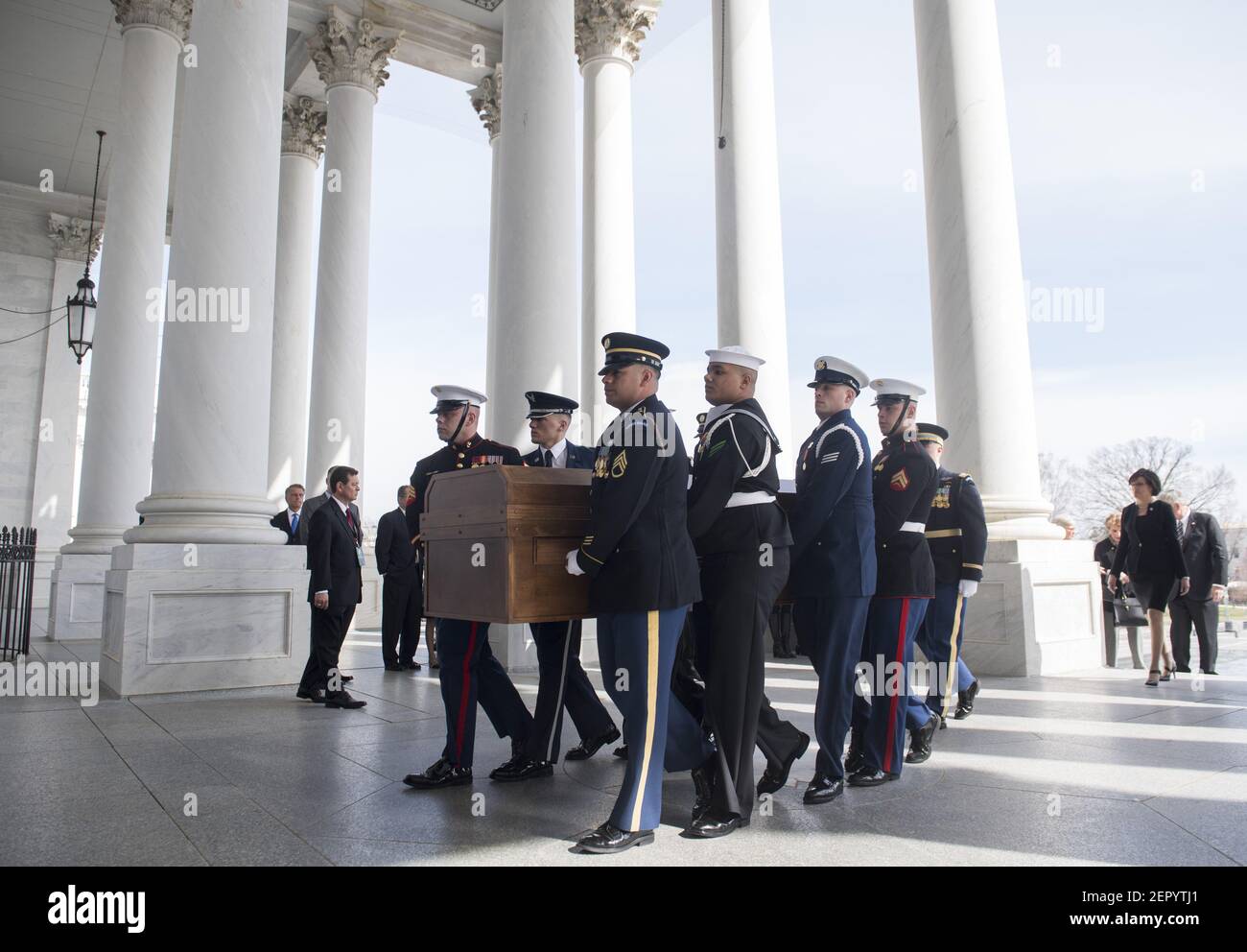 A Military Honor Guard carries the casket of Reverend Billy Graham as ...