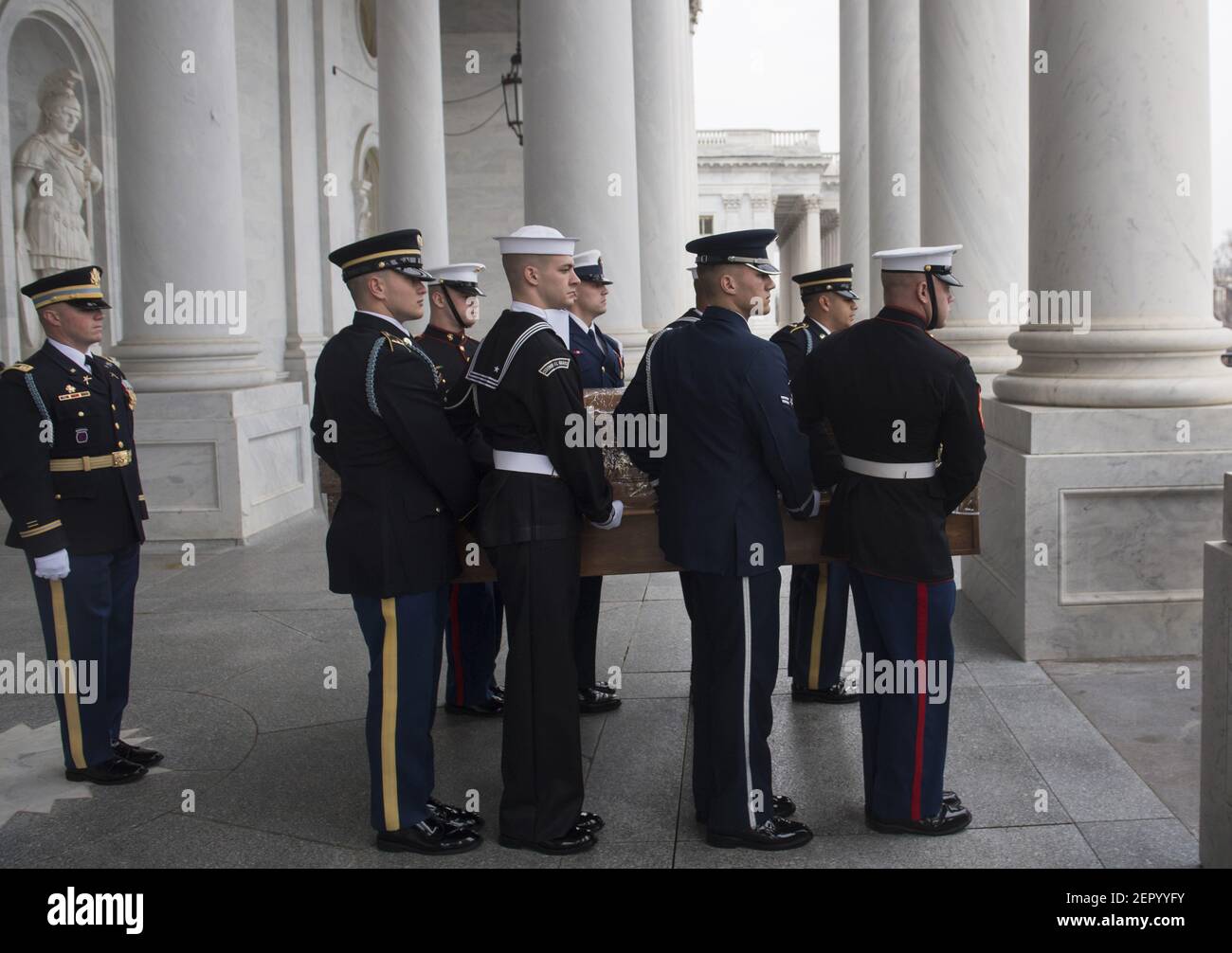 A military Honor Guard carries the casket of Reverend Billy Graham out ...