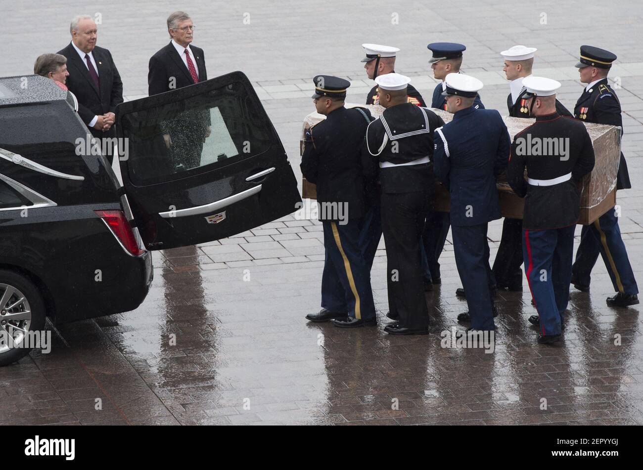 A military Honor Guard carries the casket of Reverend Billy Graham out ...