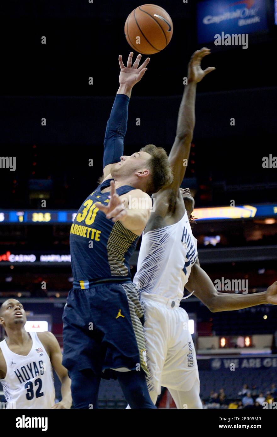 Marquette guard Andrew Rowsey (30) and Georgetown guard Jonathan ...