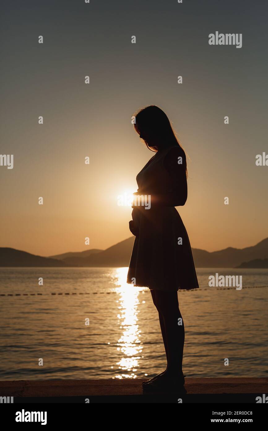 Beach sunset maternity pregnancy pregnant silhouette hi-res stock ...