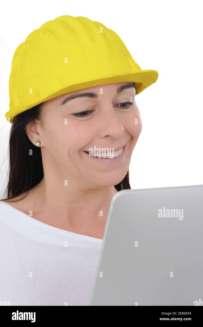 beautiful fifty year old woman smiling with yellow crash helmet and ...