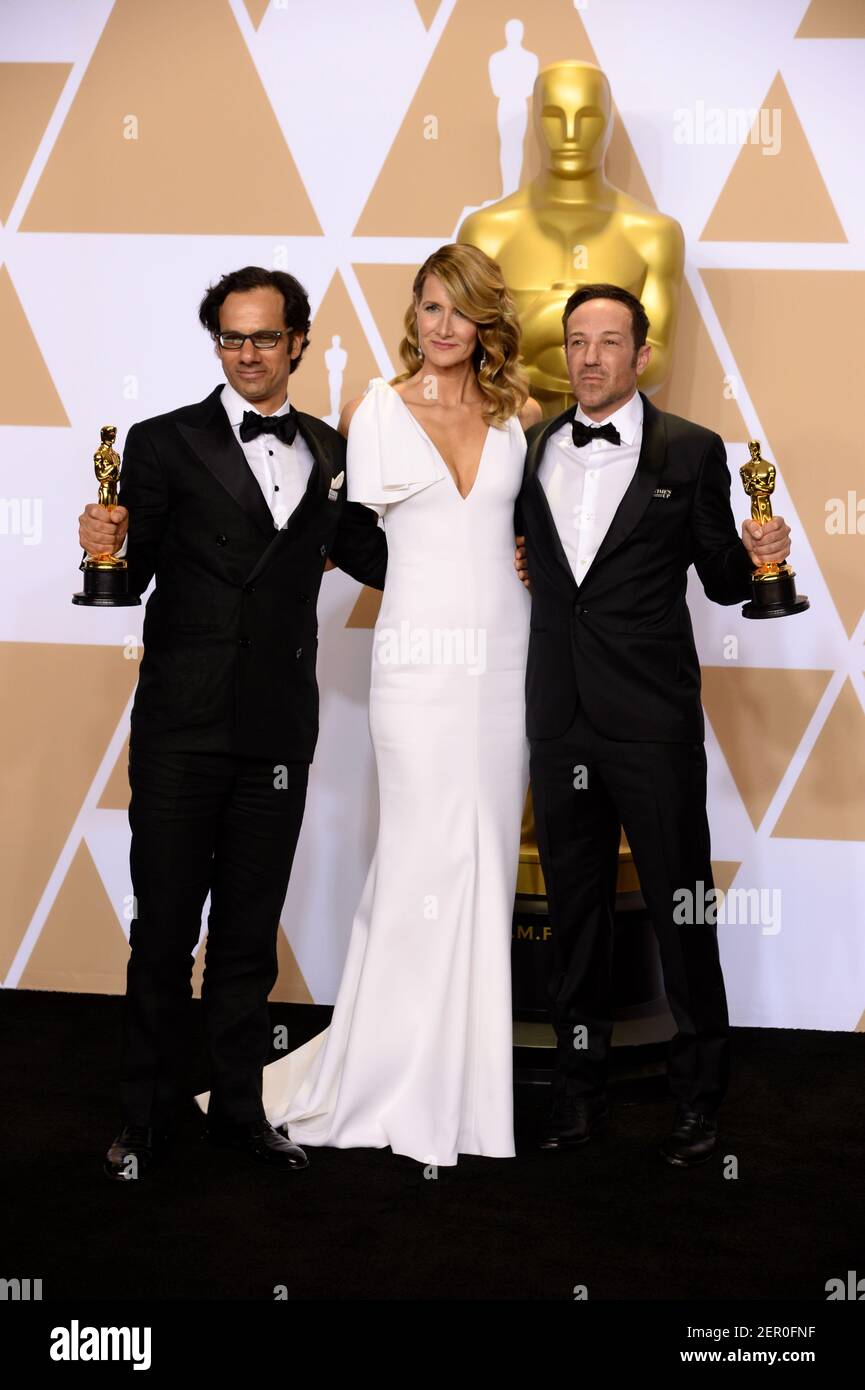 Dan Cogen and Bryan Fogel with Presenter Laura Dern posing in the Press ...
