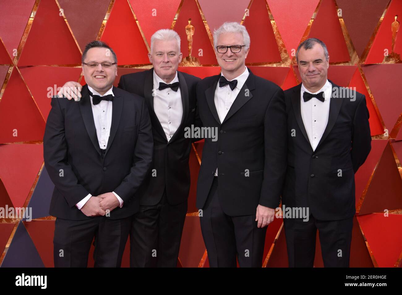 Neal Scanlan (2nd from left) walking on the red carpet during the 90th ...