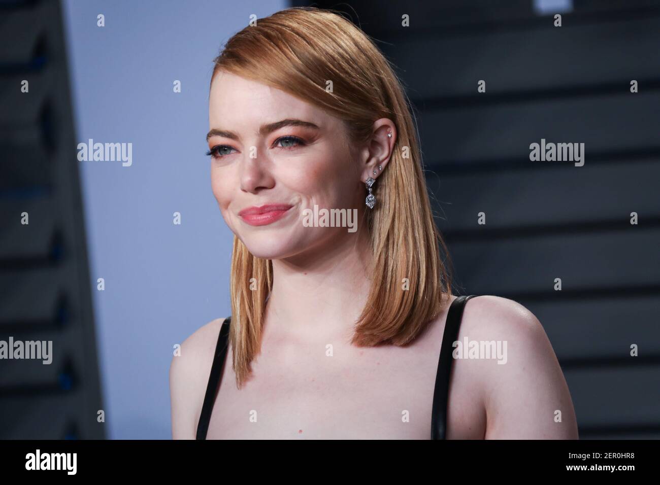Emma Stone walking on the red carpet at the 2018 Vanity Fair Oscar ...